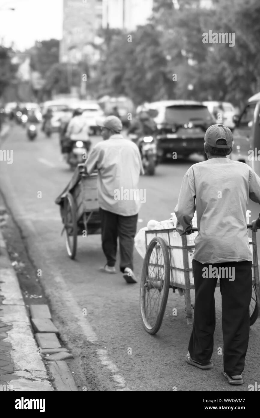 The seller's fruit and vegetable push the cart on their way home after ...