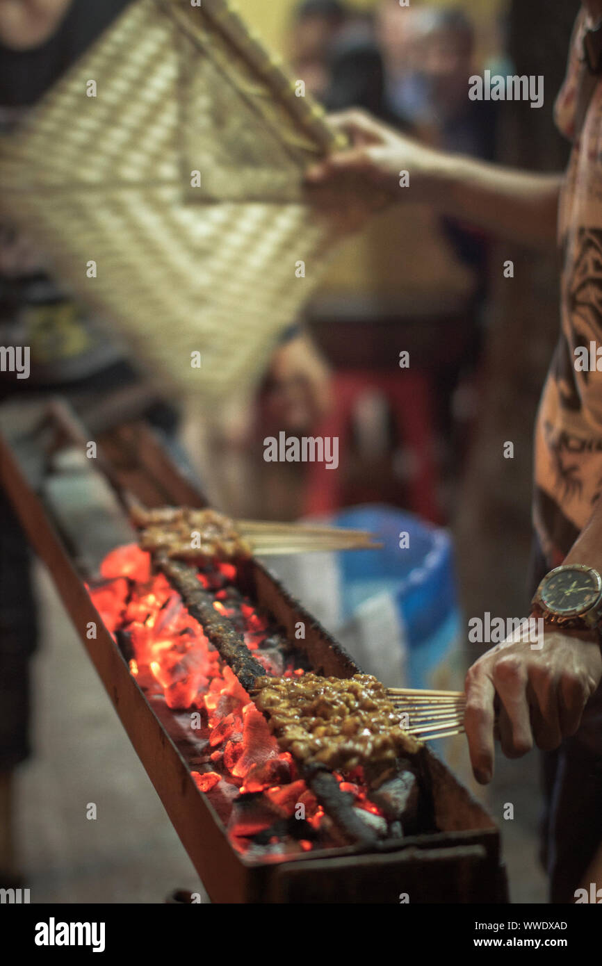Chicken satay grill at a busy street food market Stock Photo - Alamy