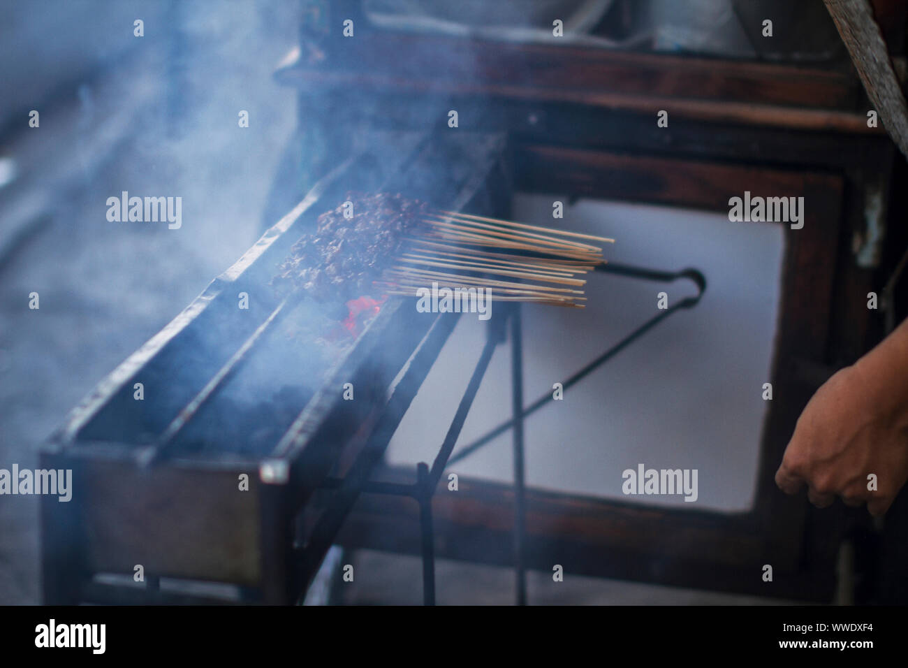 Chicken satay grill at a busy street food market Stock Photo - Alamy