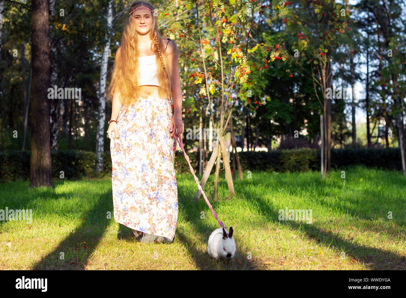 girl with a rabbit on a leash walk park care pet Stock Photo - Alamy