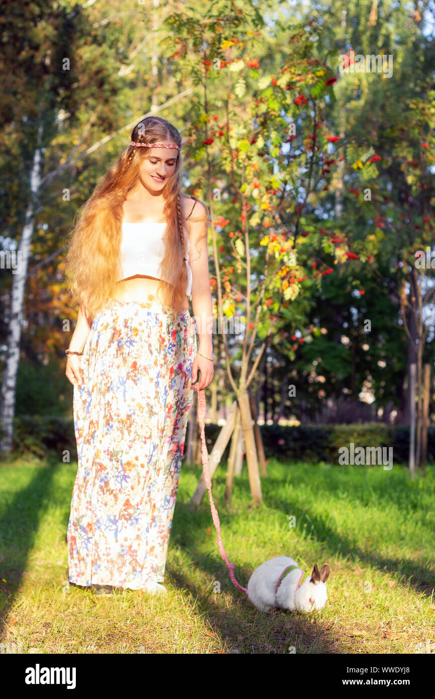 girl with a rabbit on a leash walk park care pet Stock Photo - Alamy