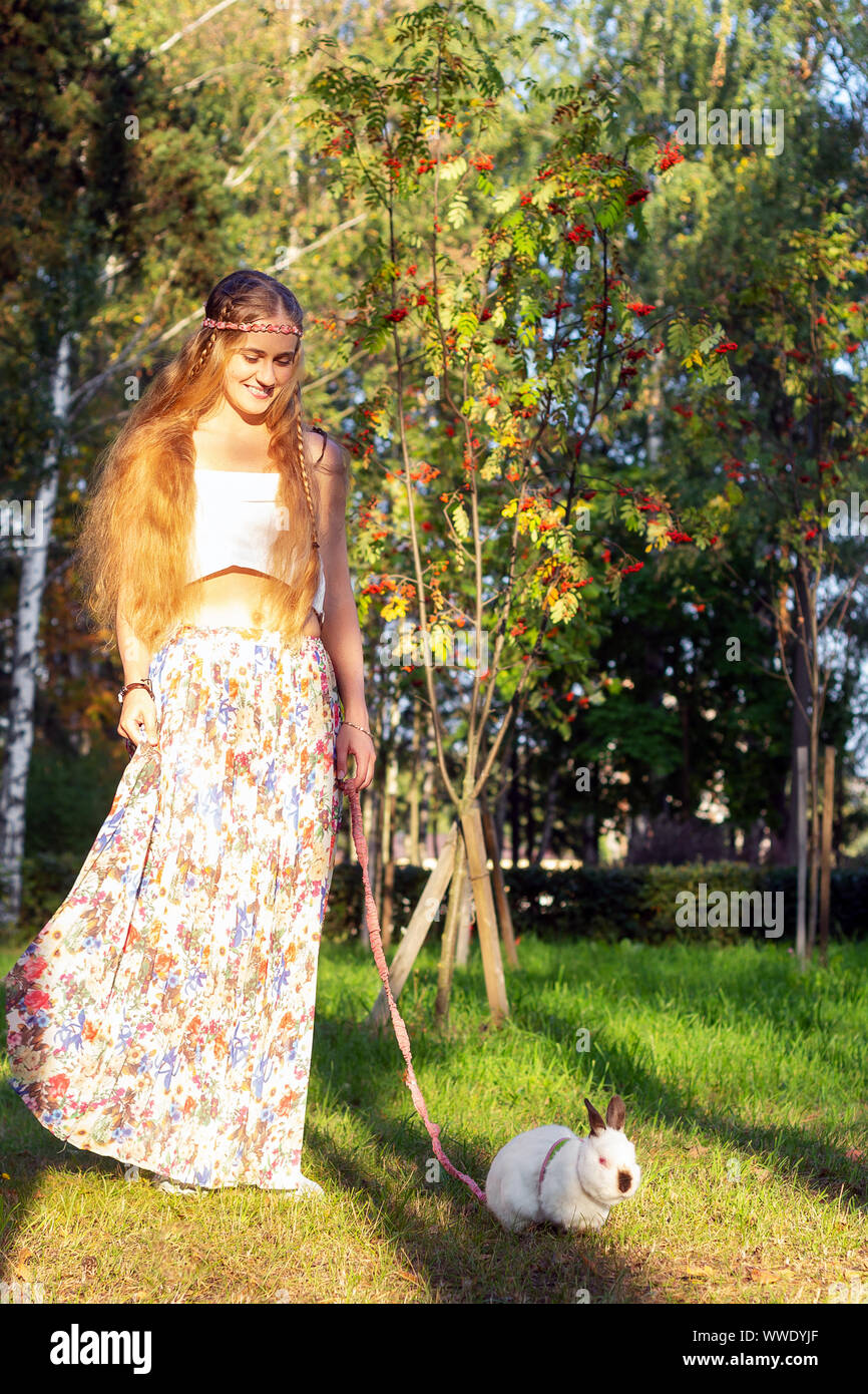 girl with a rabbit on a leash walk park care pet Stock Photo - Alamy