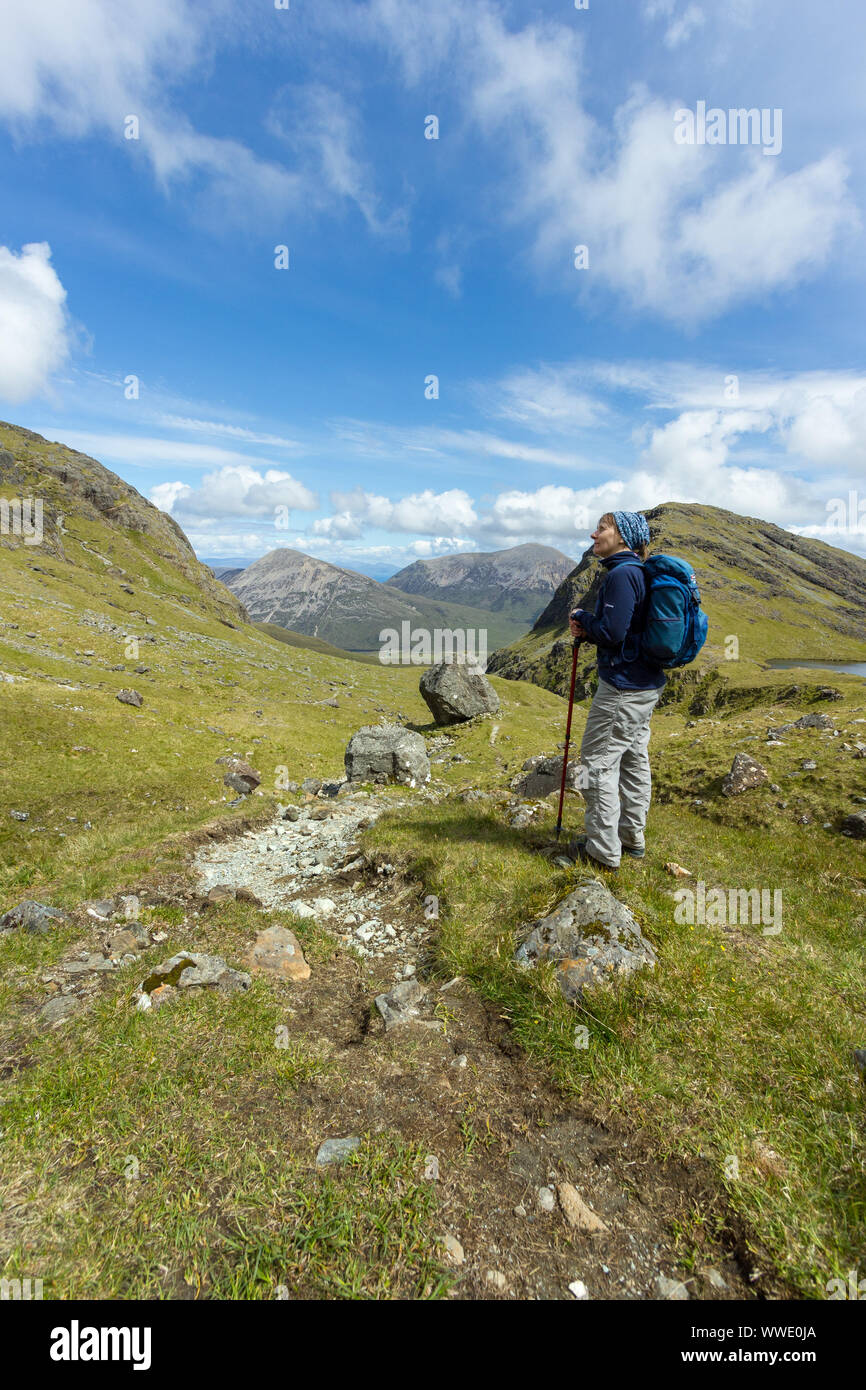 Female mountain walker high on the slopes of Blaven above Fionna Choire ...