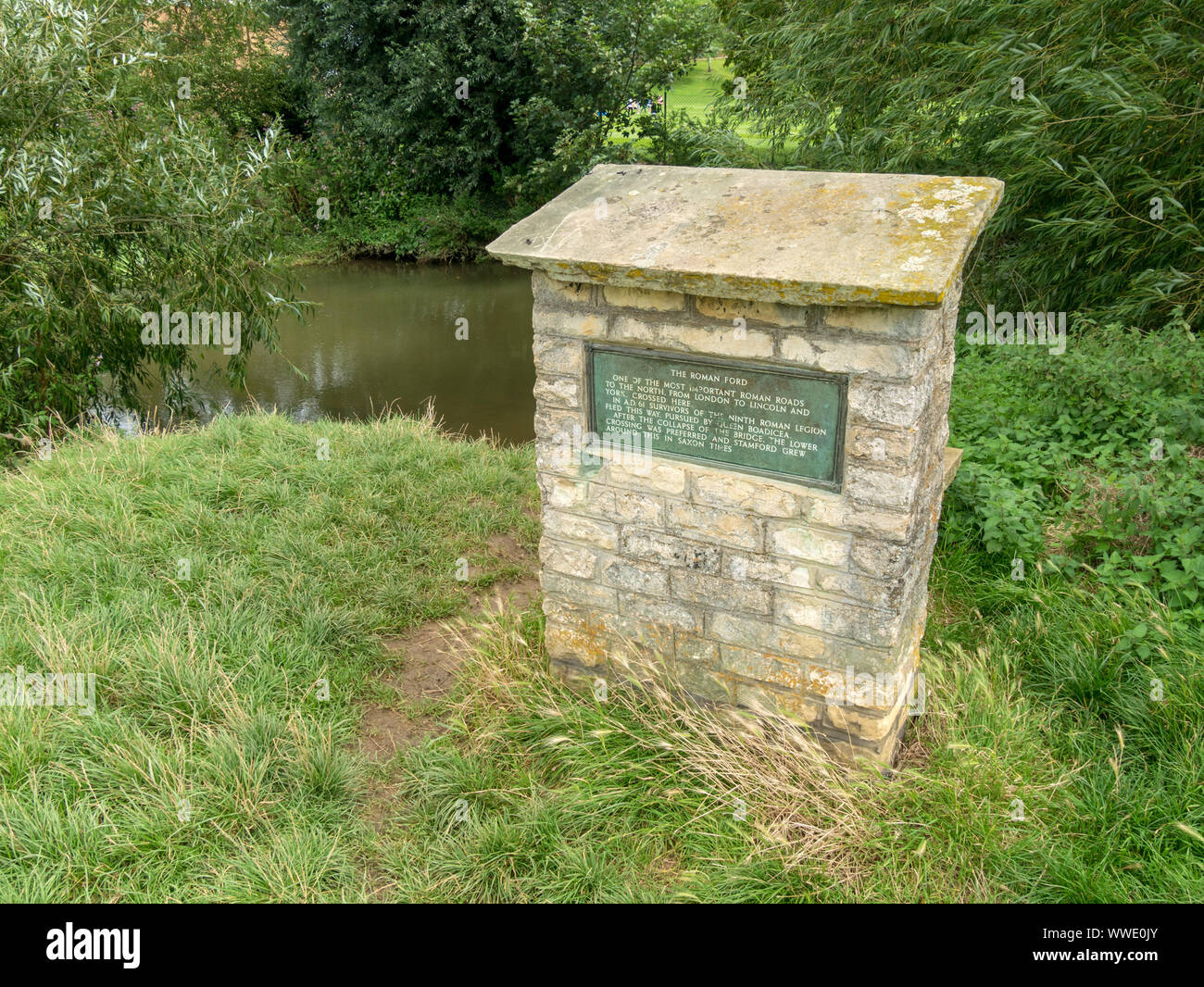 Stone plinth with plaque marking the site of the old Roman Great North ...