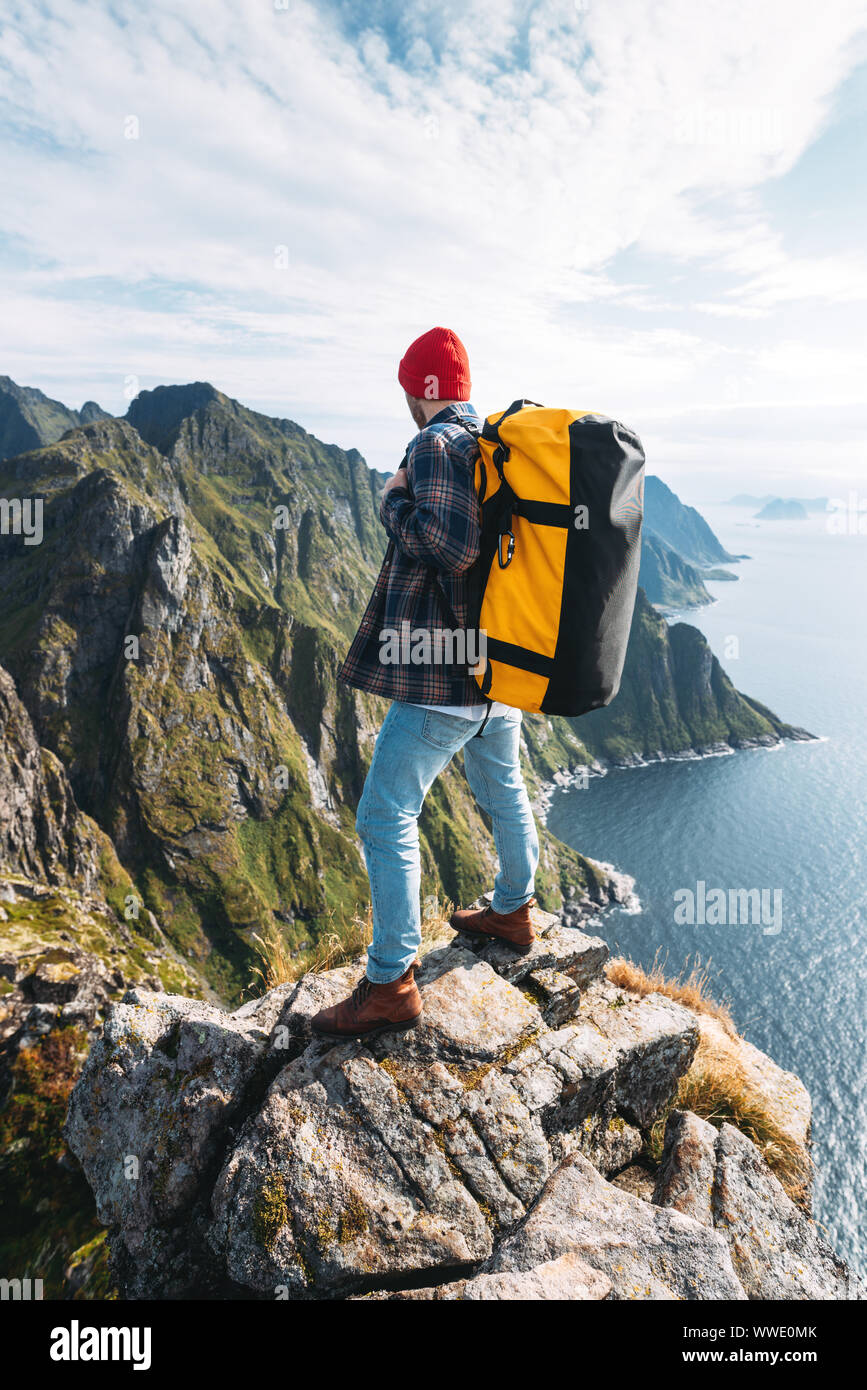 Man wearing professional backpack traveling alone on the high mountains. Traveler standing on ...