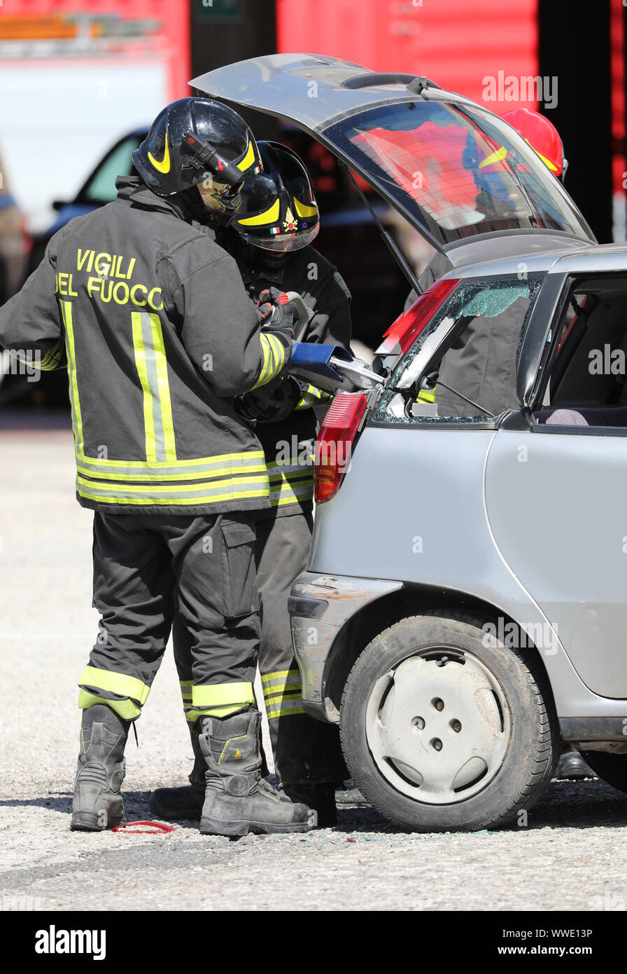Rome, RM, Italy - May 16, 2019: road accident and the firemen who cut ...