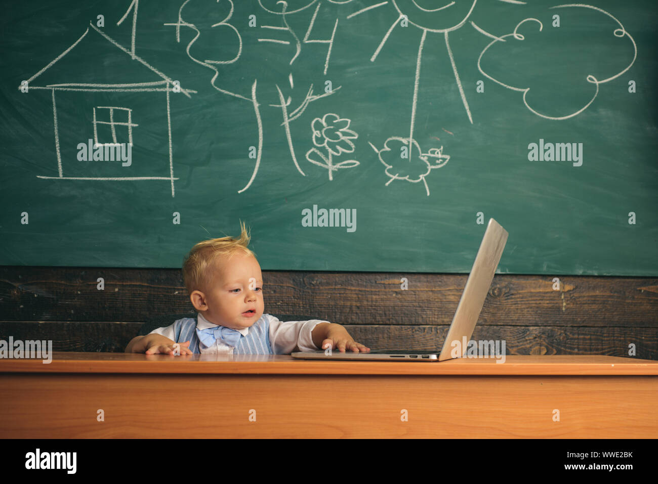 Small child use free video call in computer class. Toddler boy make ...
