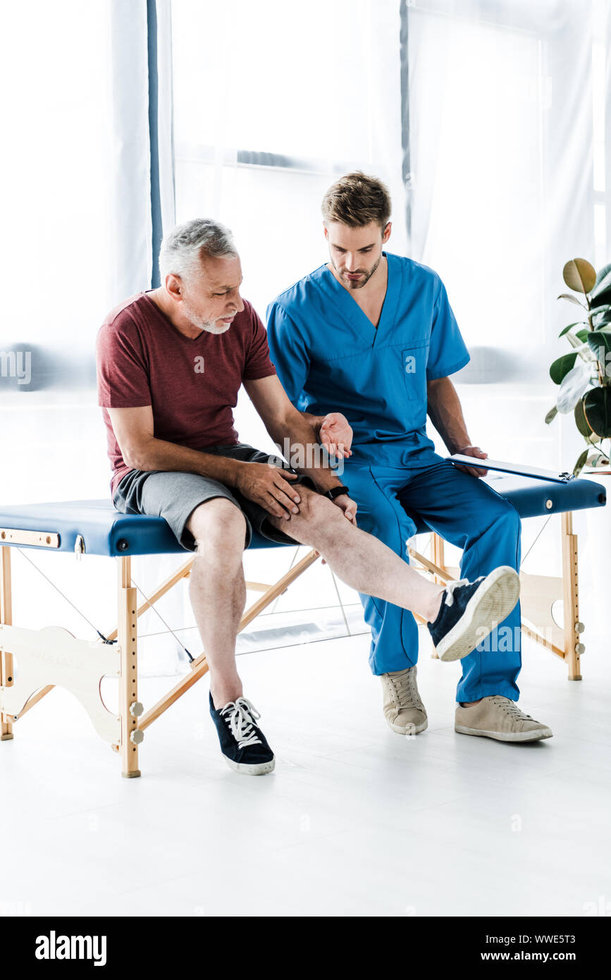 Doctor sitting near leg hi-res stock photography and images - Alamy