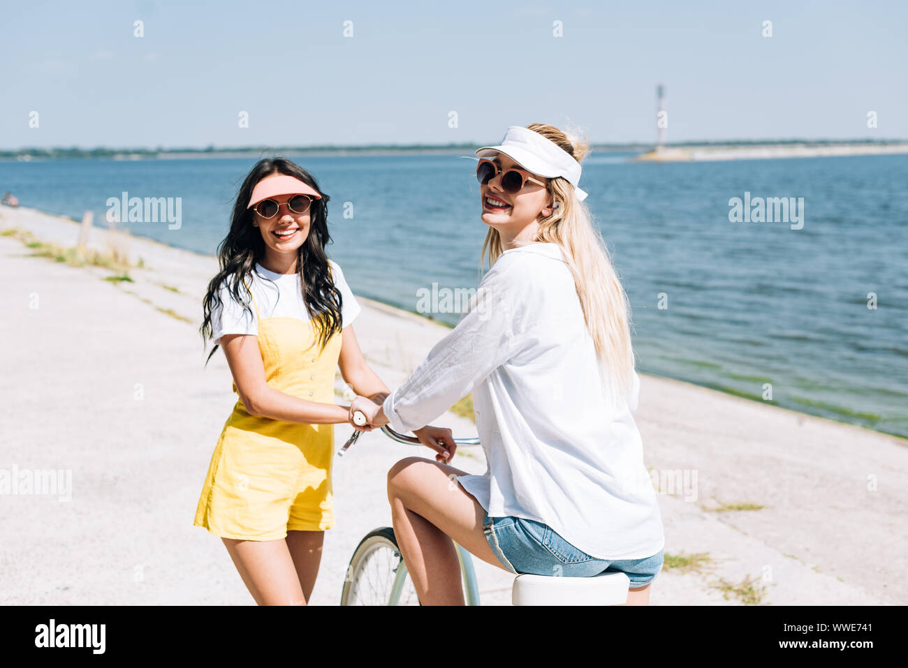 Girls riding bike two girls cycling hi-res stock photography and images ...