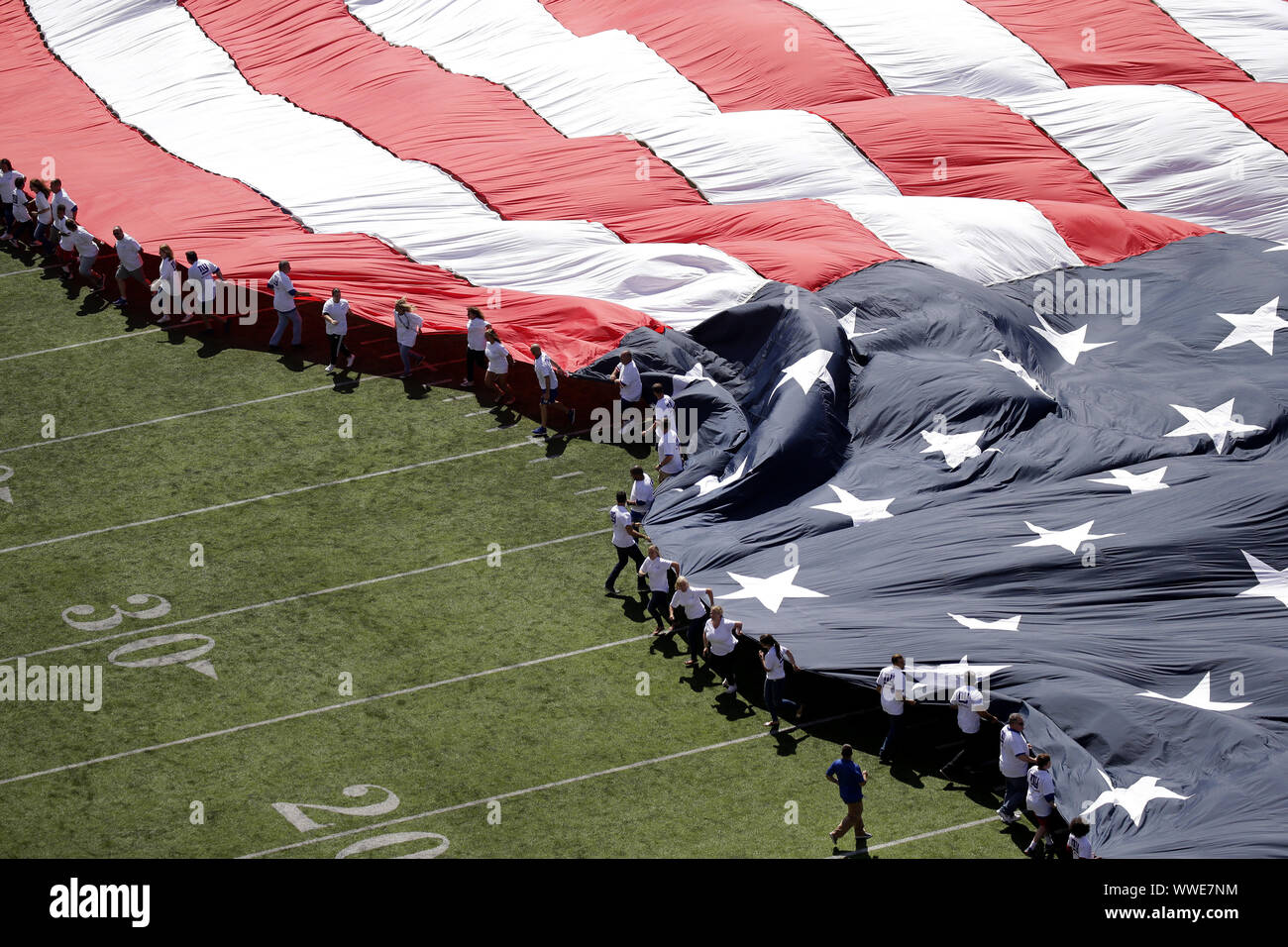 A giant American Flag is rolled out on the field for the National ...