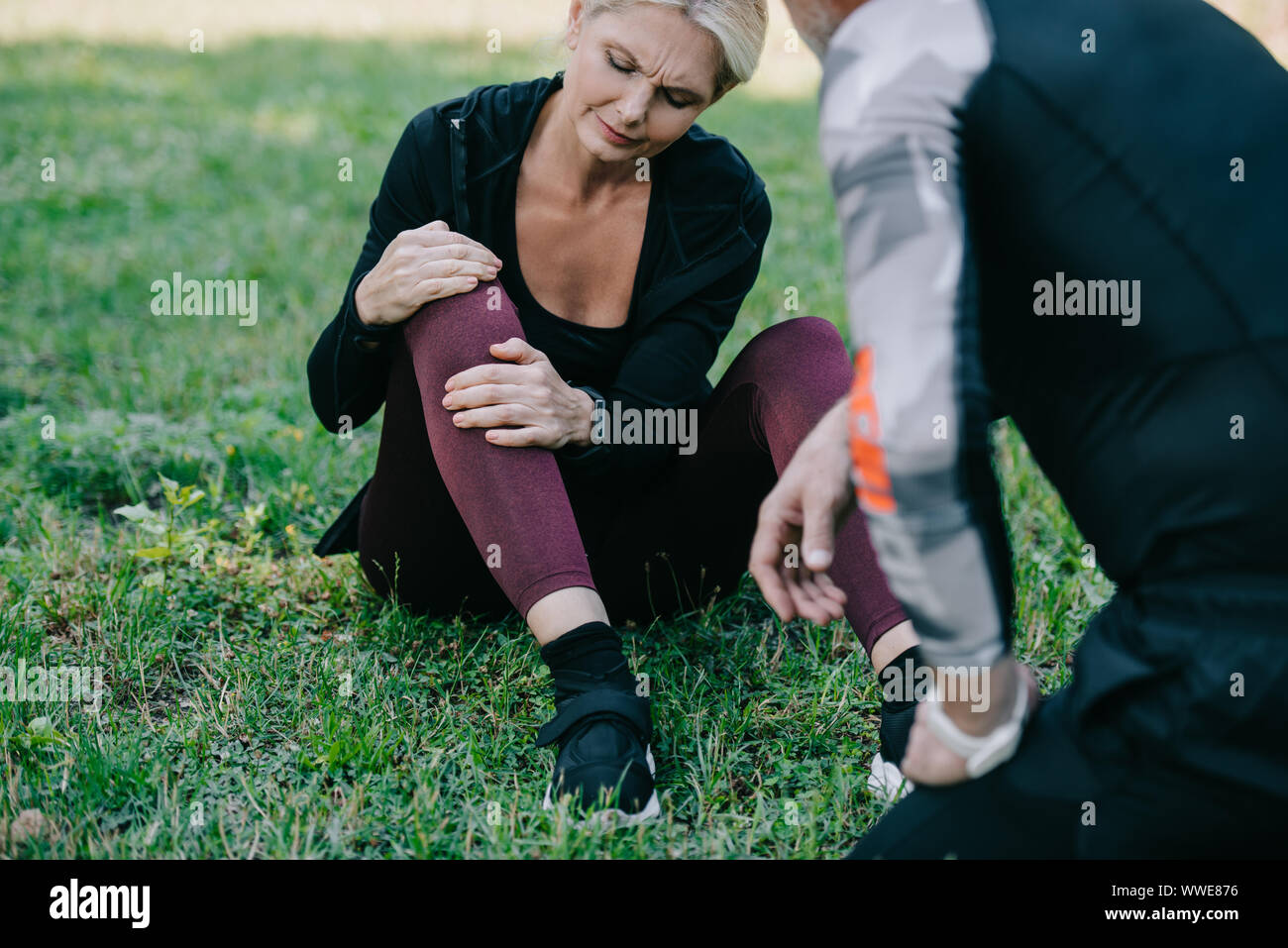 Mature woman touching leg hi-res stock photography and images - Alamy