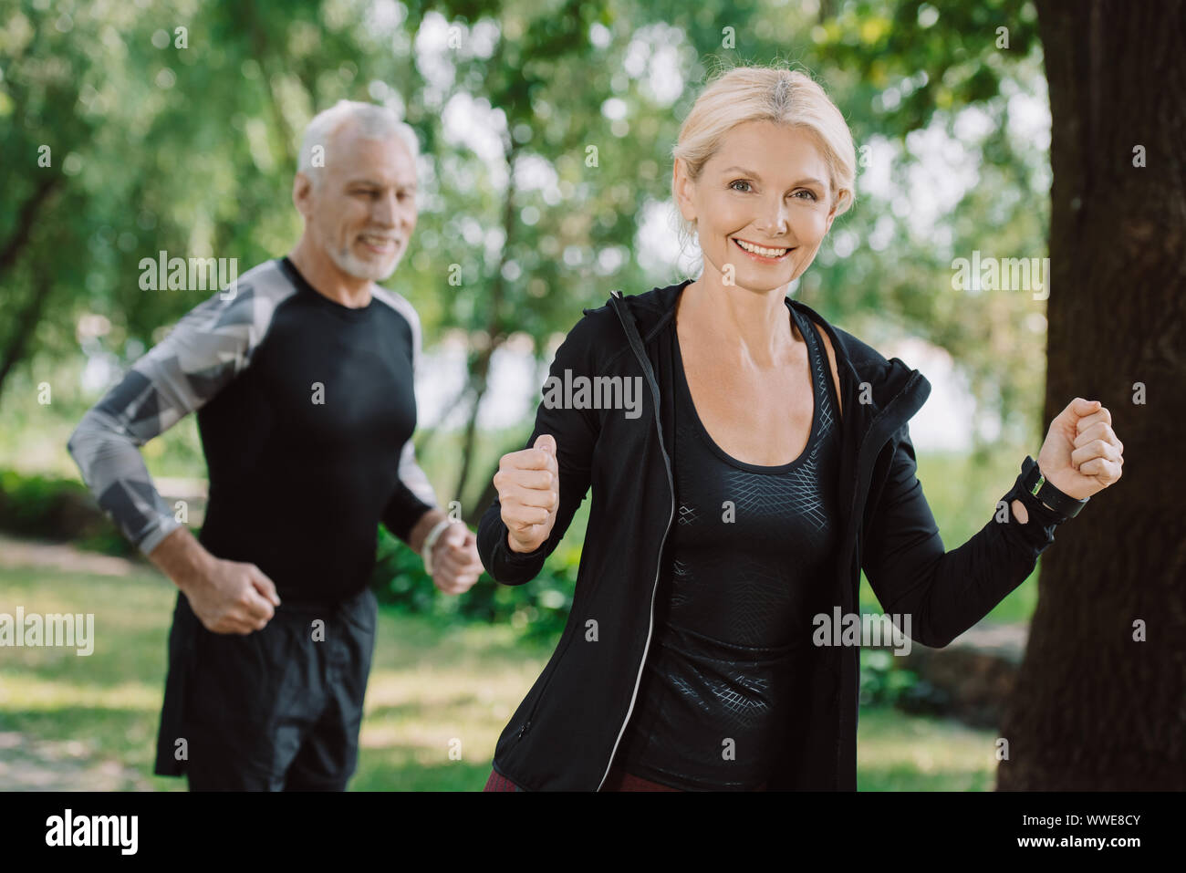 Cheerful people jogging in park hi-res stock photography and images - Alamy