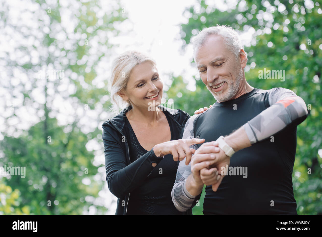 Hand pointing on watch hi-res stock photography and images - Alamy