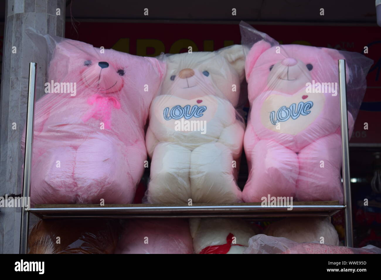 Different size and color teddy bears kept in front of a shop for sell ...