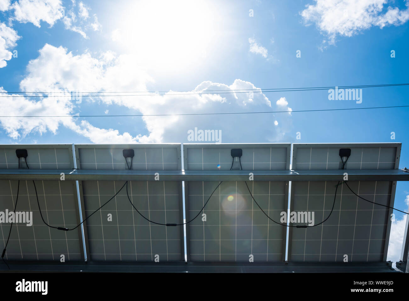 blue solar energy batteries, sun and cloudy sky outside Stock Photo - Alamy