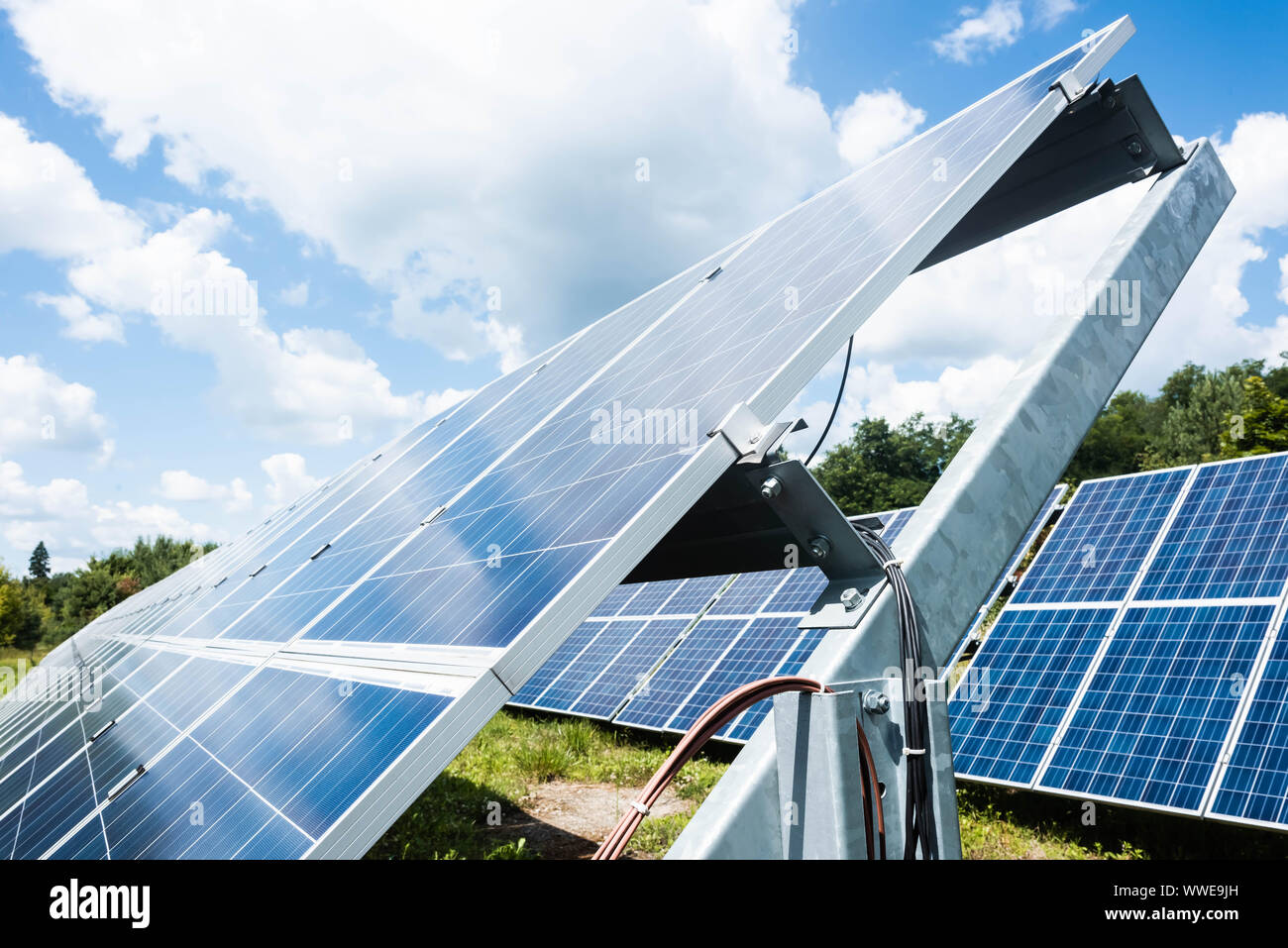 blue solar energy batteries, green grass and cloudy sky outside Stock ...