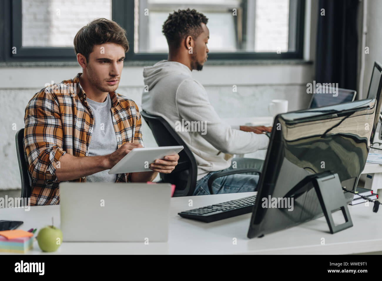 Two young programmers working together hi-res stock photography and ...