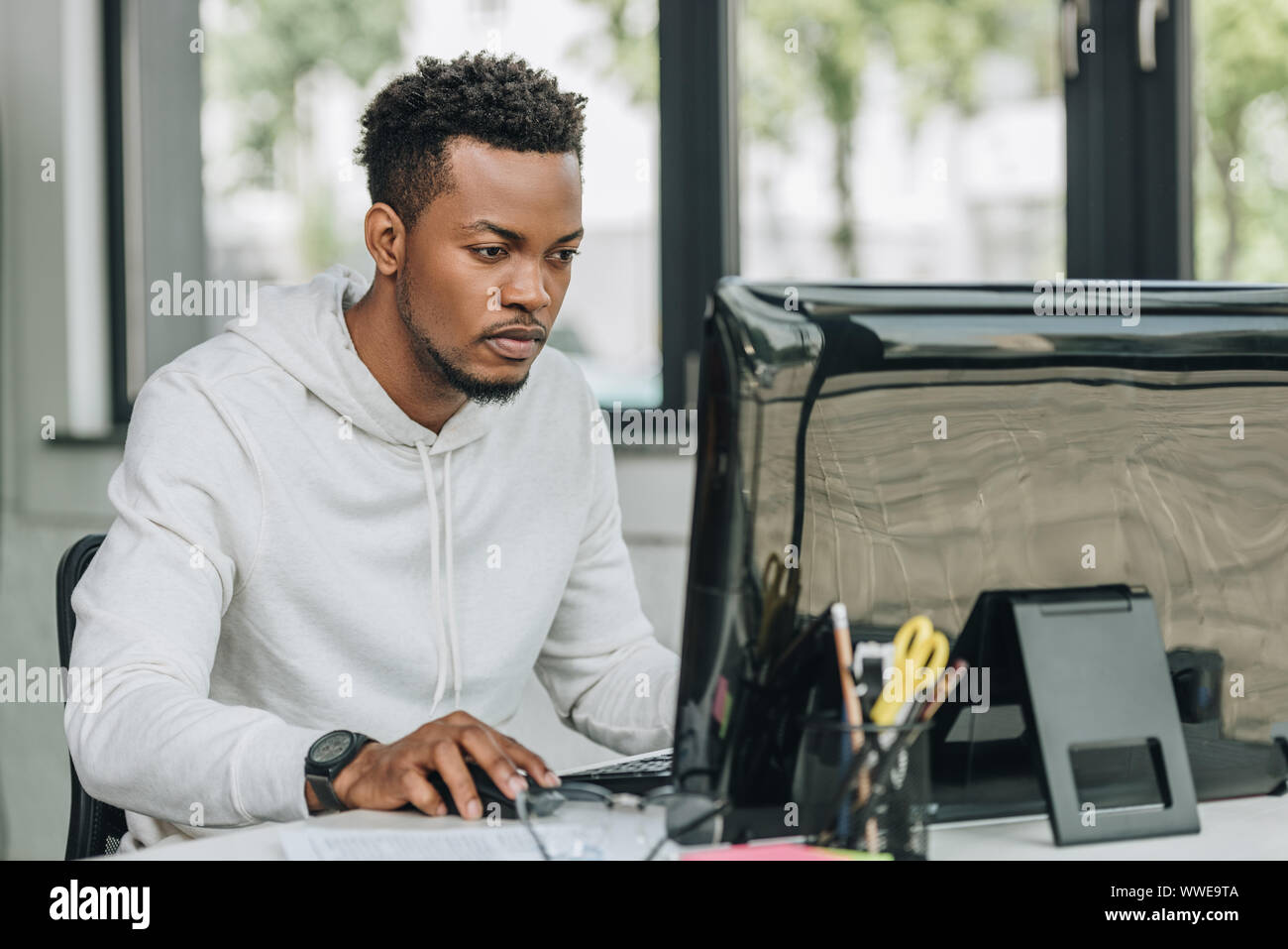 attentive african american programmer working on computer in office ...