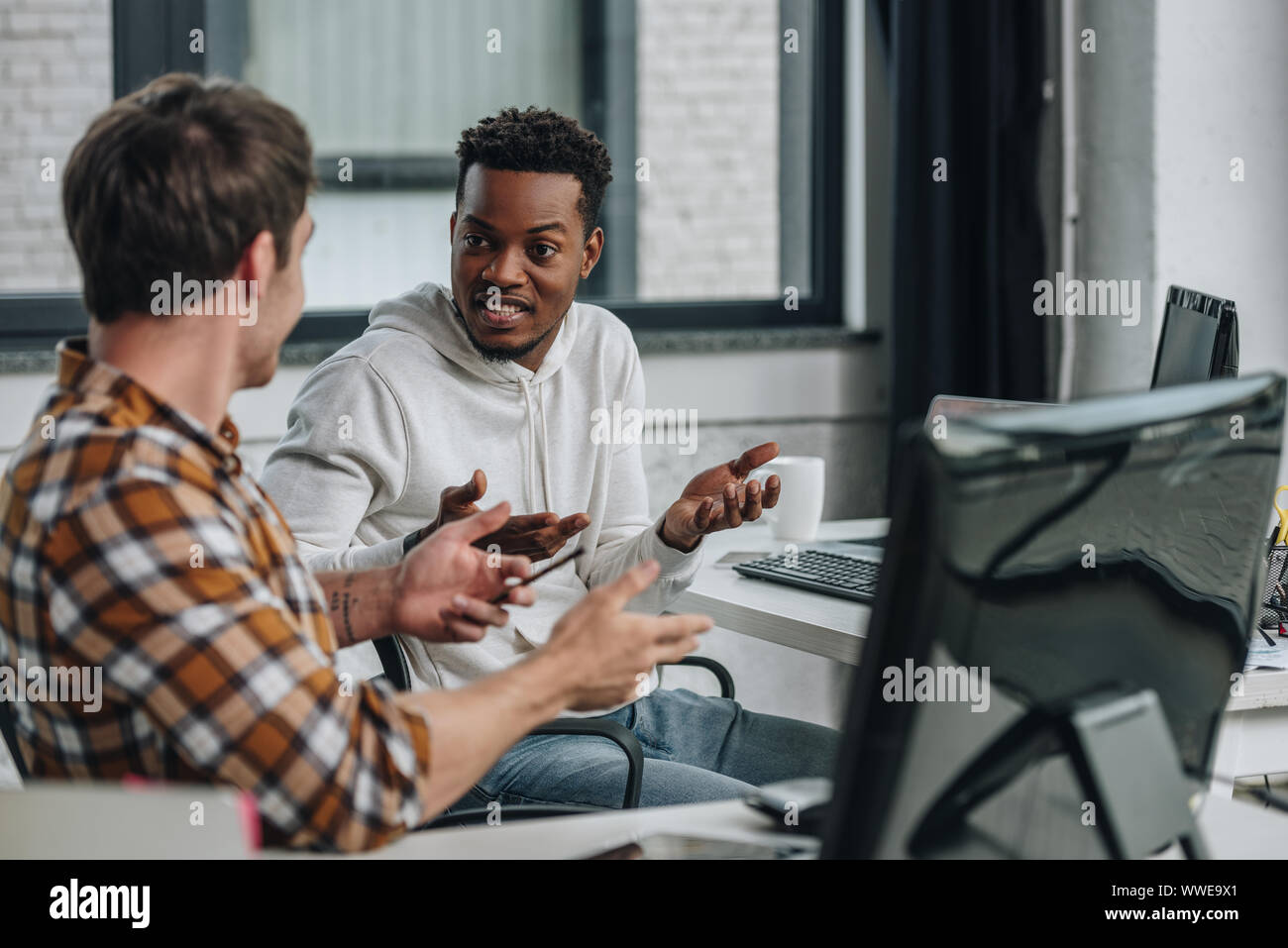 Two young programmers working together hi-res stock photography and ...