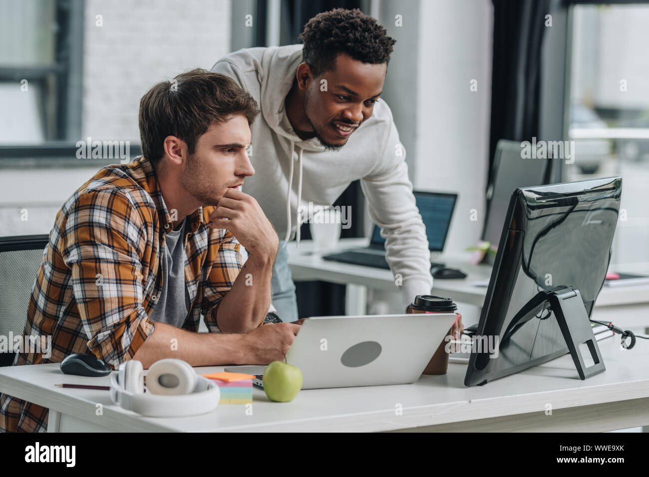 two serious multicultural programmers working in office together Stock ... two serious multicultural programmers working in office together Stock ...