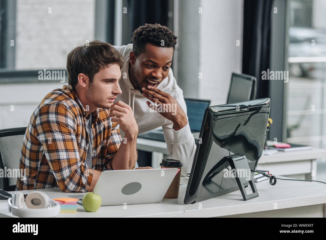 Developers at computer with headphones hi-res stock photography and ...