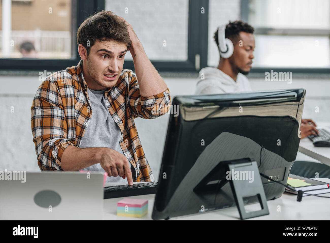 Developers at computer with headphones hi-res stock photography and ...