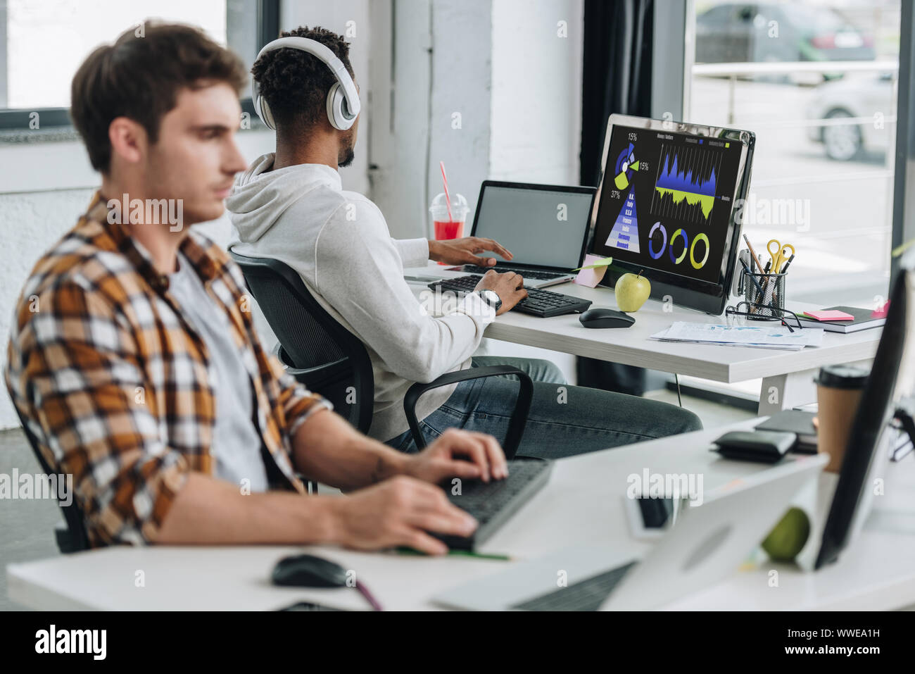 Developers at computer with headphones hi-res stock photography and ...