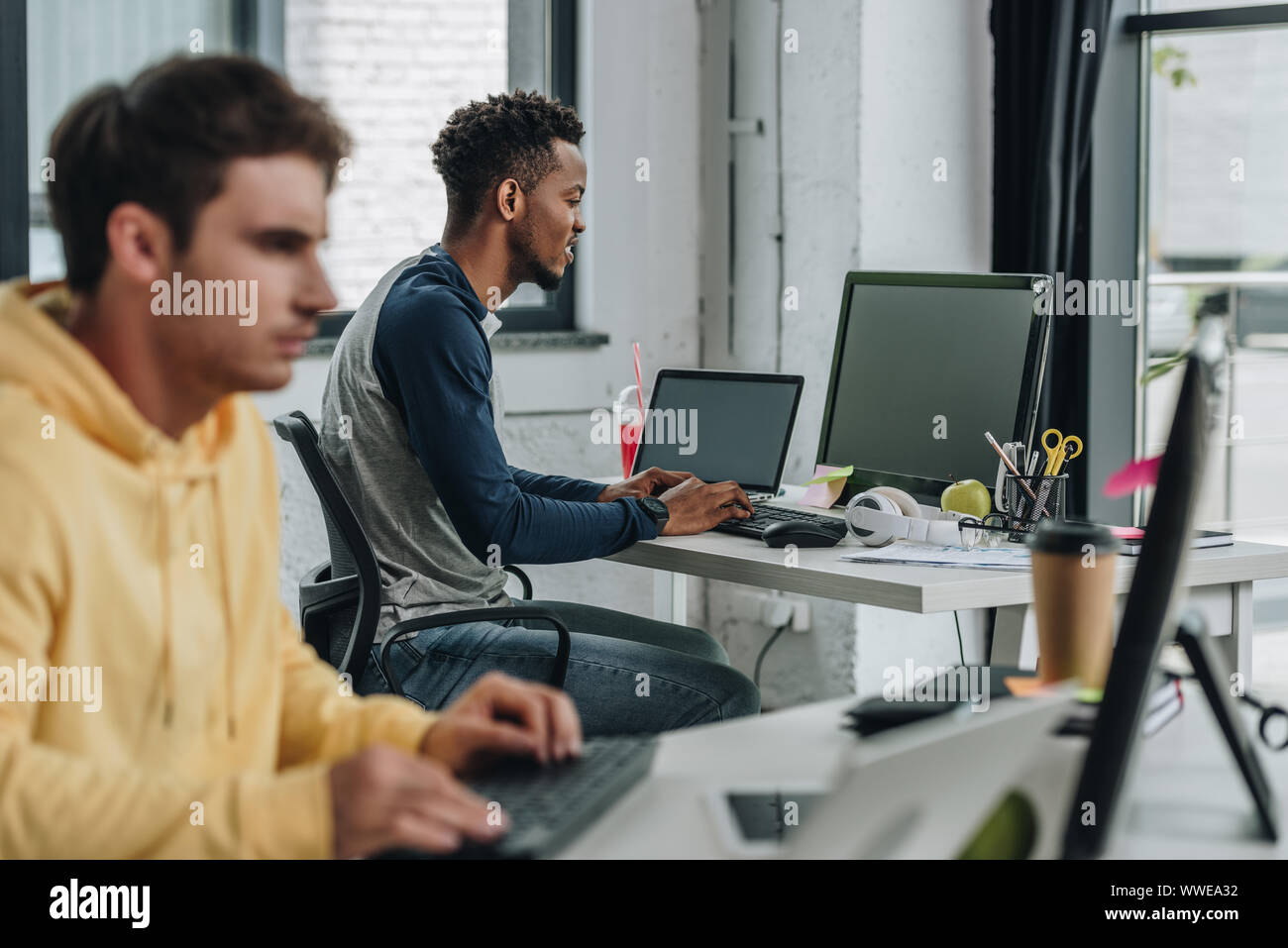 selective focus of two young multicultural programmers working in ... selective focus of two young multicultural programmers working in ...