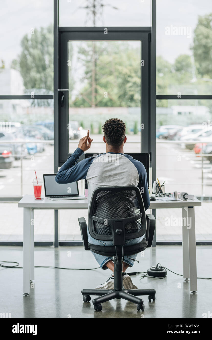 back view of young african american programmer showing idea sign while ...