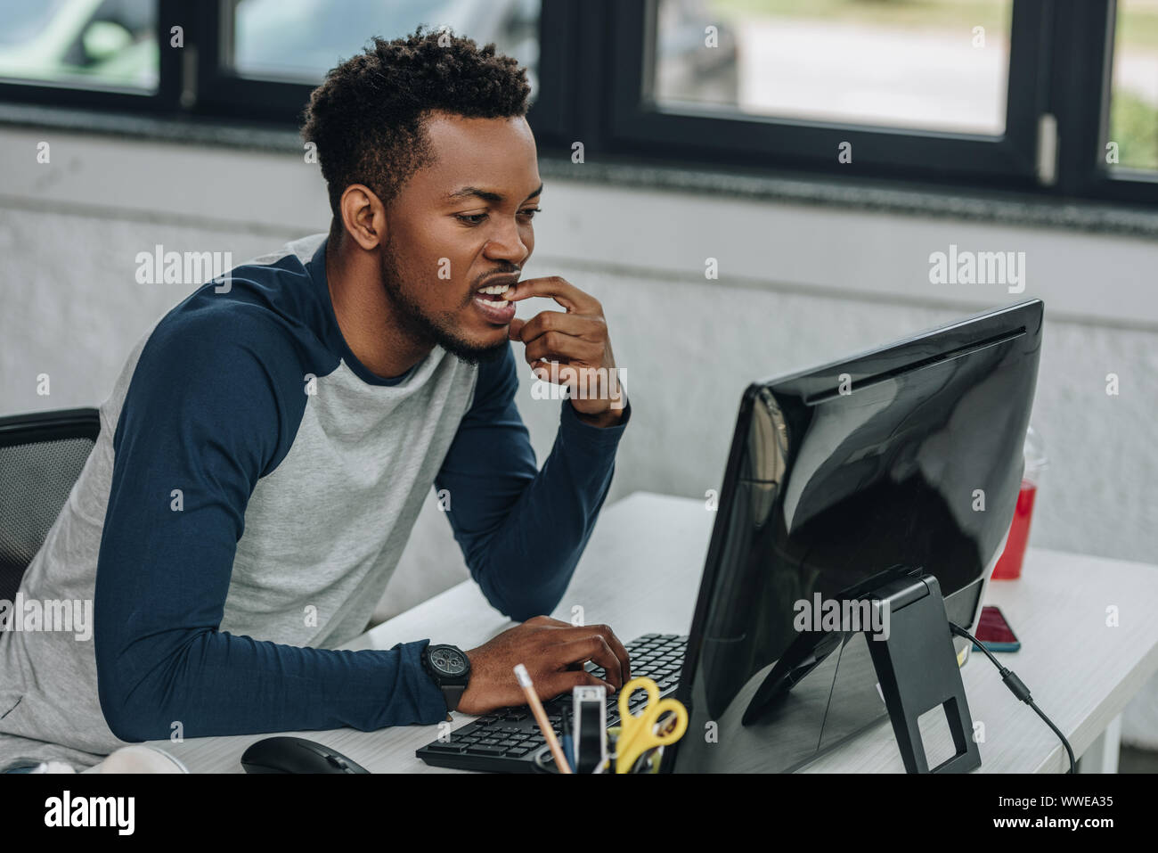 concentrated african american programmer working on computer in office Stock Photo - Alamy