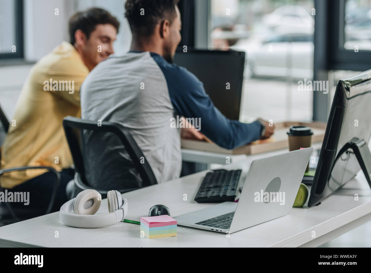back view of african american programmer working in office together ...