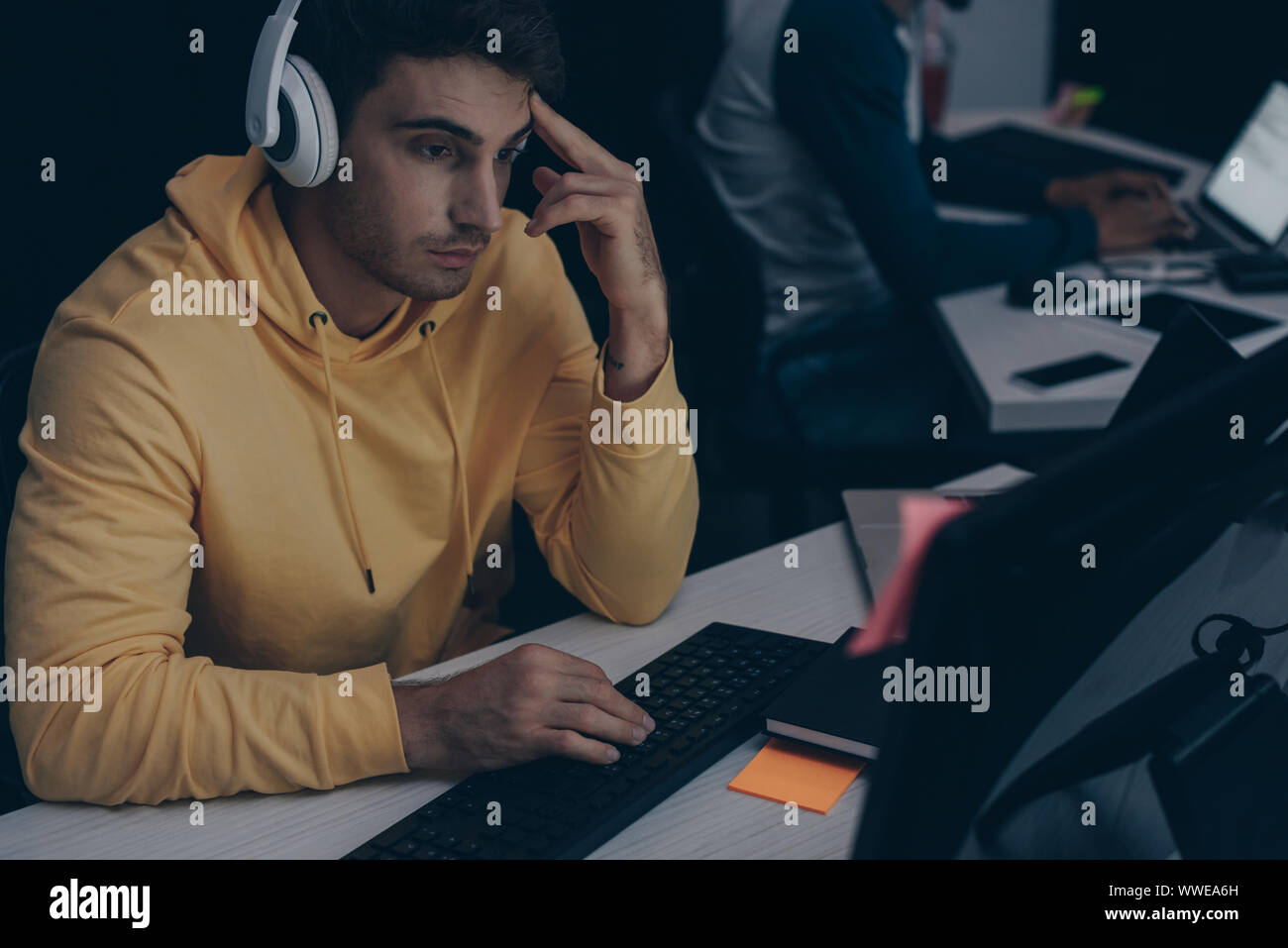 Developers at computer with headphones hi-res stock photography and ...
