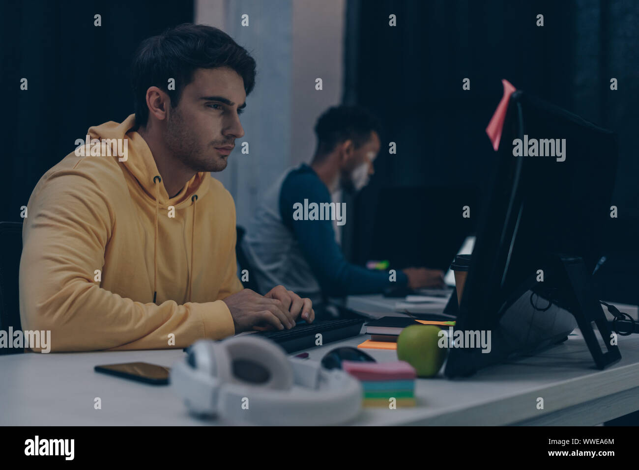 Selective Focus Of Serious Programmer Looking At Monitor While Working