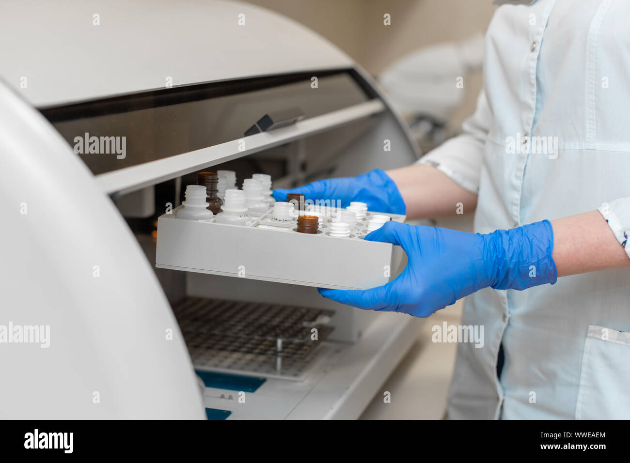 Laboratory technician test blood in automatic blood sample analyzer ...