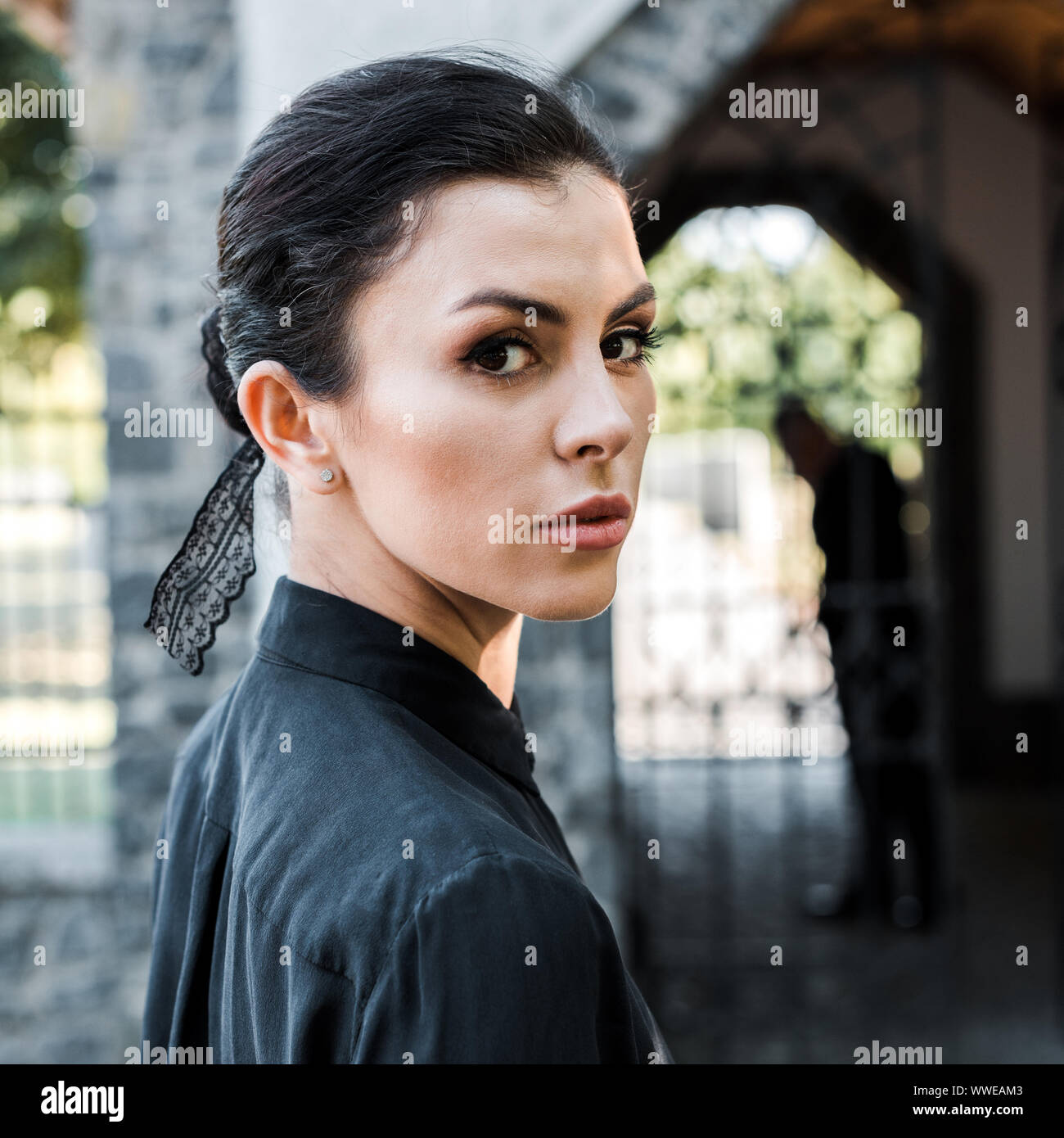 attractive woman in formal wear looking at camera on funeral Stock ...