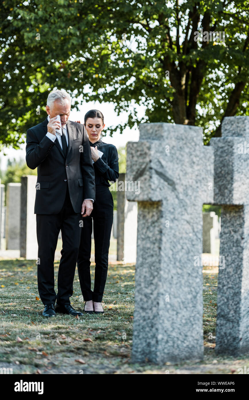People Crying At A Grave