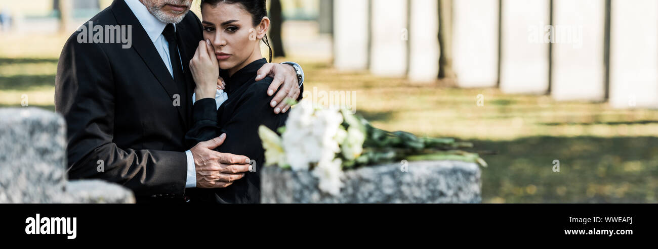 panoramic shot of senior man hugging woman on funeral Stock Photo - Alamy