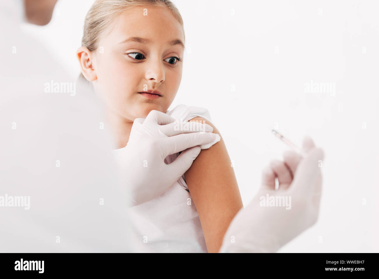 partial view of pediatrist doing injection to child isolated on white ... partial view of pediatrist doing injection to child isolated on white ...
