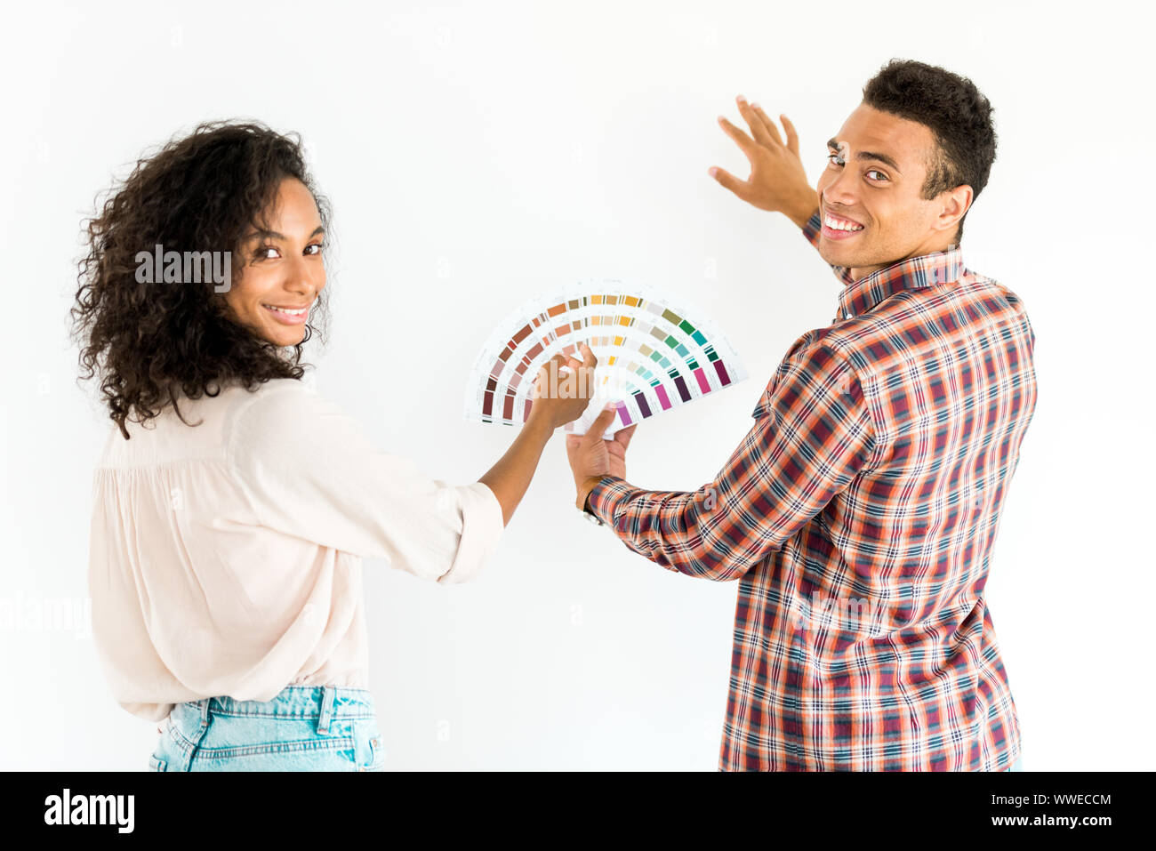 african american man and woman trying to choose color for their wall ...