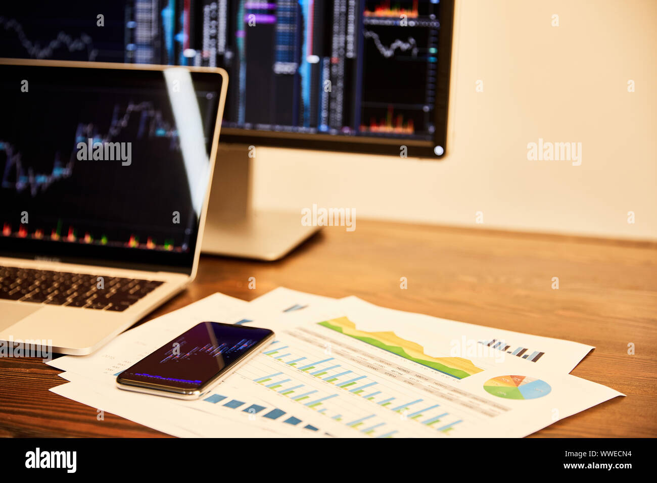 laptop and computer with charts and graphs, documents and smartphone on ...