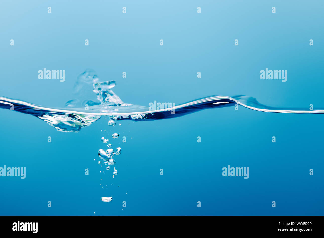transparent pure water with splash and drops on blue background Stock ...