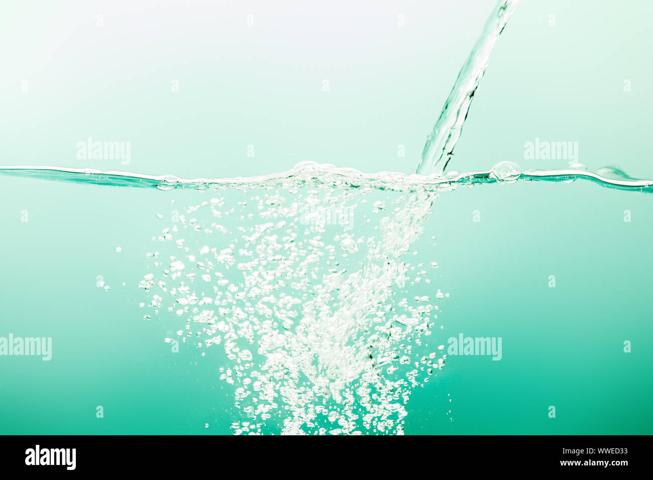 transparent pure water with stream and bubbles on green background ...