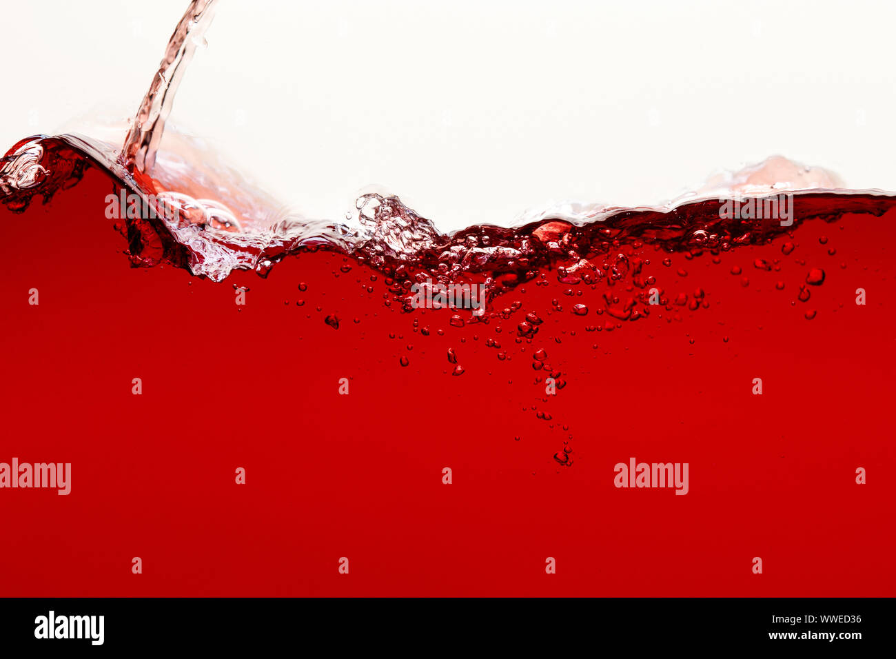 flowing red bright liquid with splash and bubbles isolated on white ...