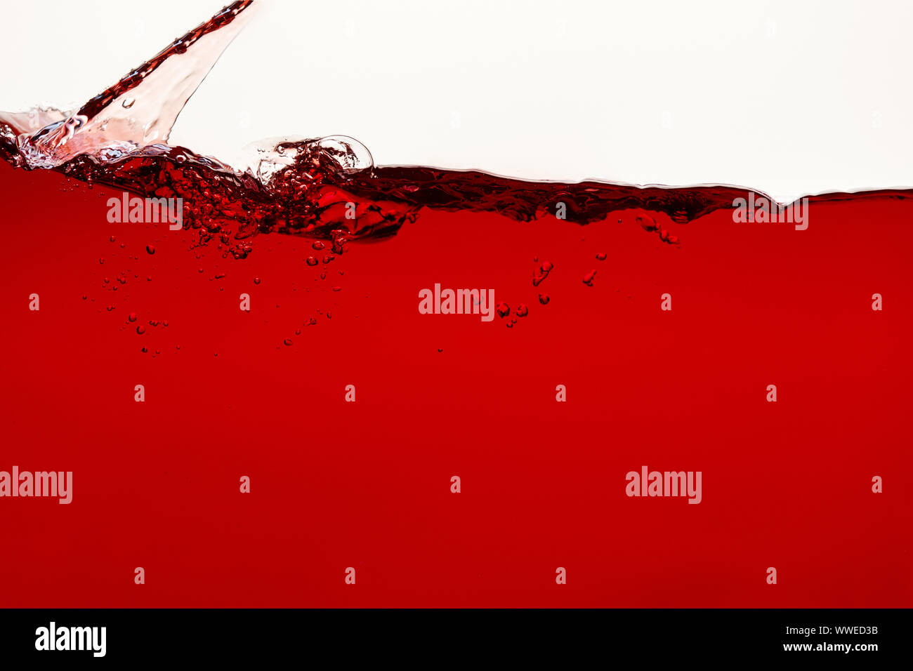 flowing red liquid with splash and bubbles isolated on white Stock ...