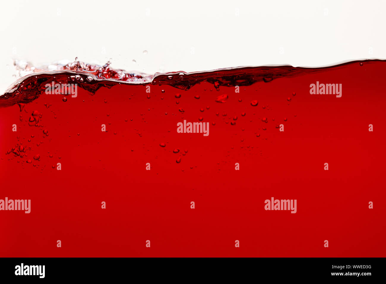 red bright liquid with bubbles isolated on white Stock Photo - Alamy