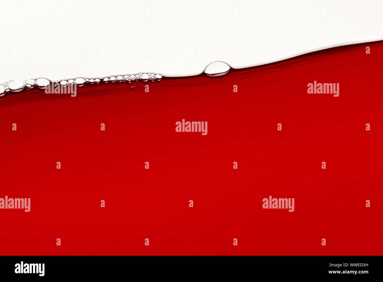 red bright liquid with bubbles on surface isolated on white Stock Photo ...