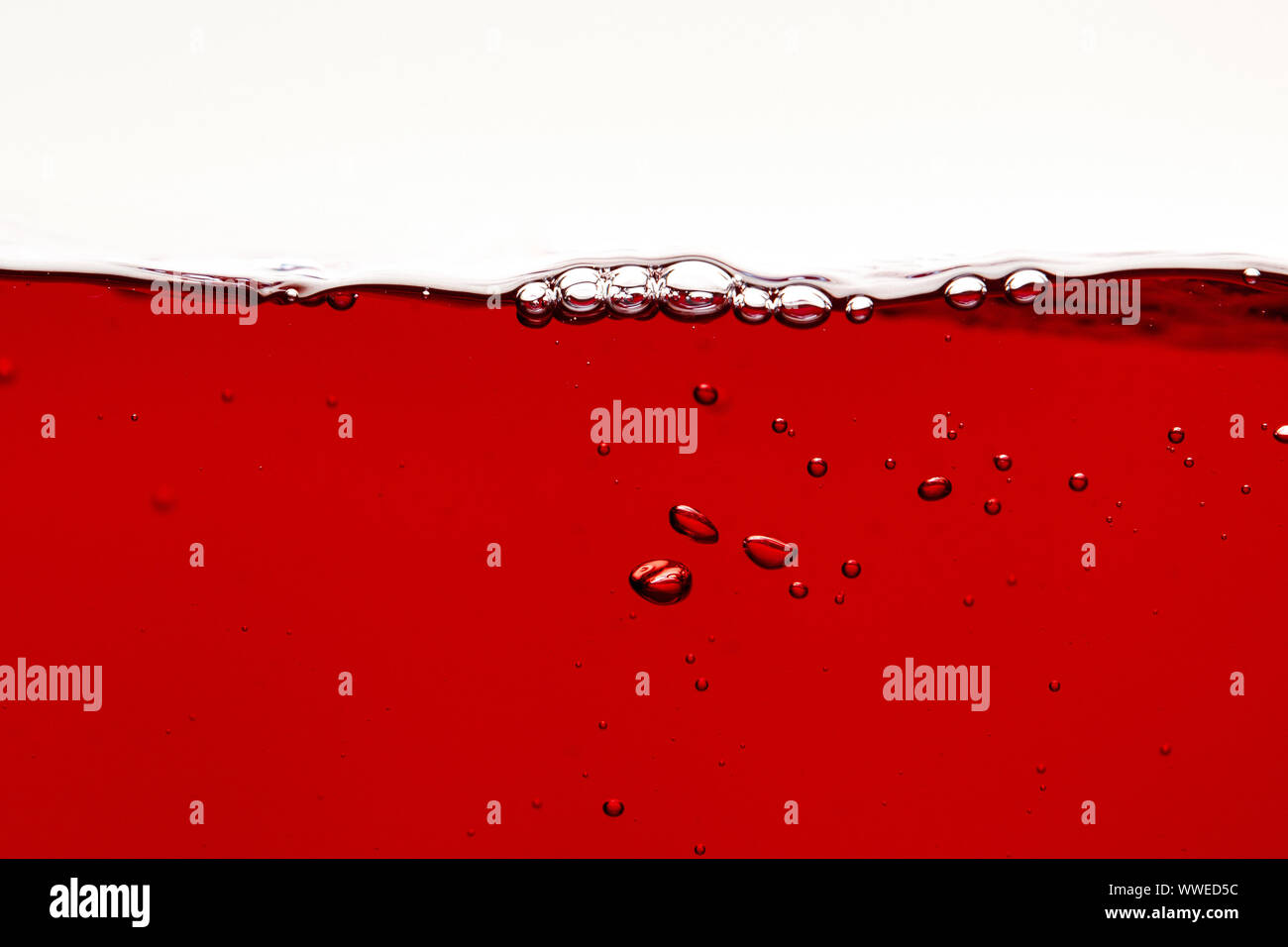 red bright liquid with bubbles on surface isolated on white Stock Photo ...