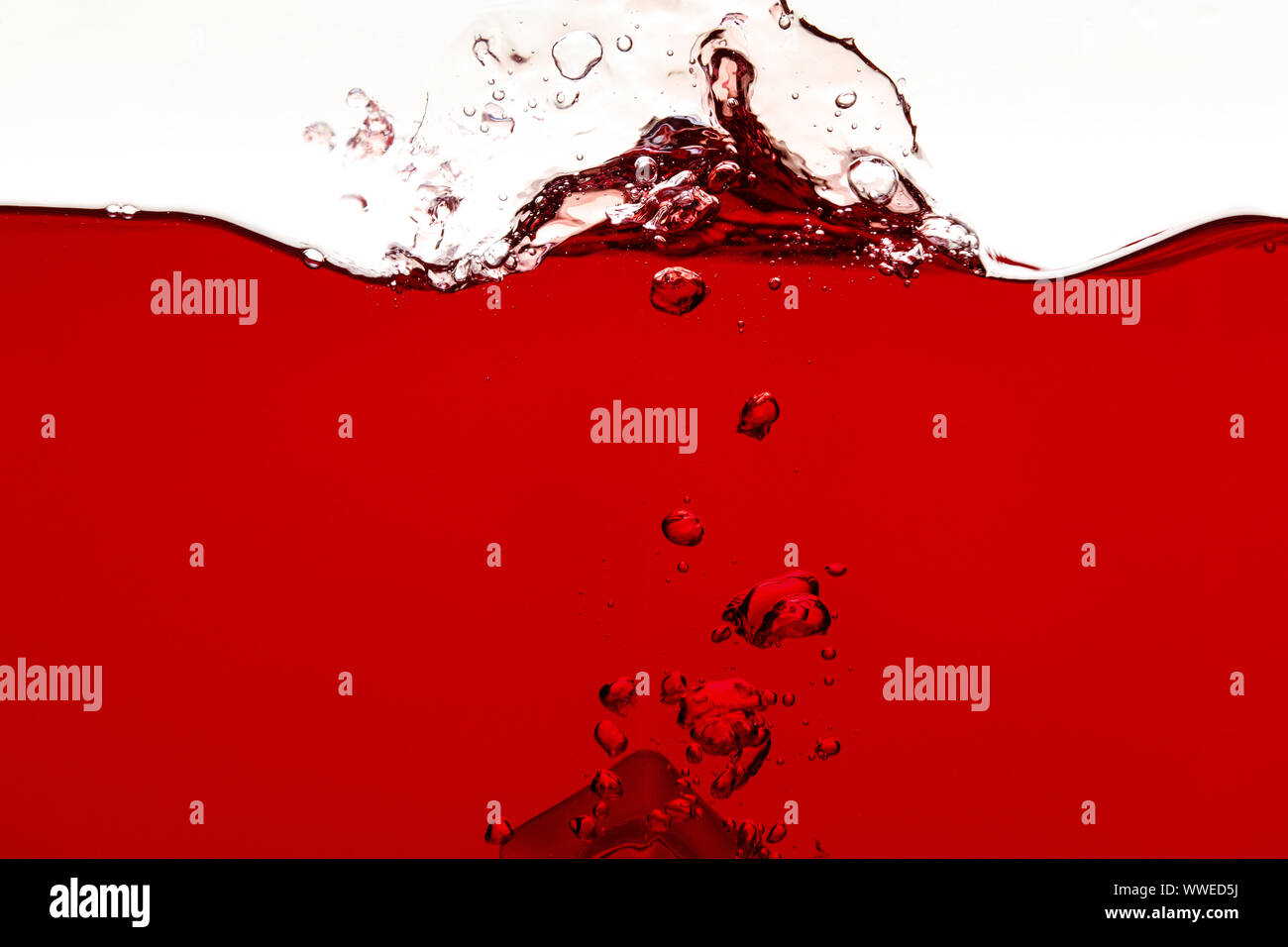 red liquid with splash and bubbles isolated on white Stock Photo - Alamy