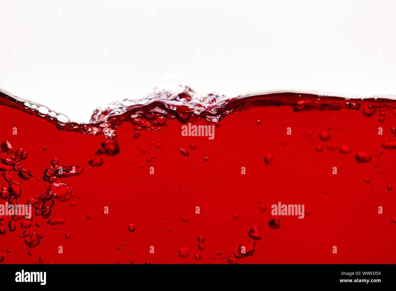 red bright liquid with wave and bubbles isolated on white Stock Photo ...