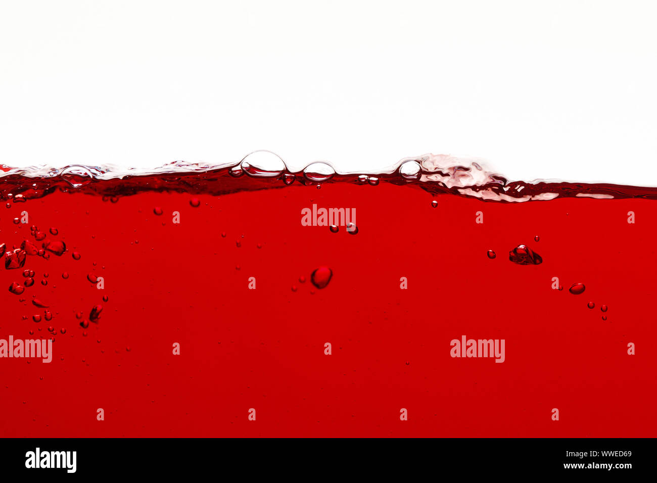 red colorful liquid with bubbles on surface isolated on white Stock ...